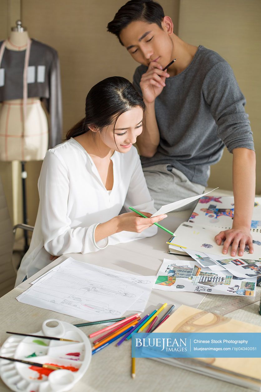 Two Chinese fashion designers drawing sketch-High-res stock photo for download