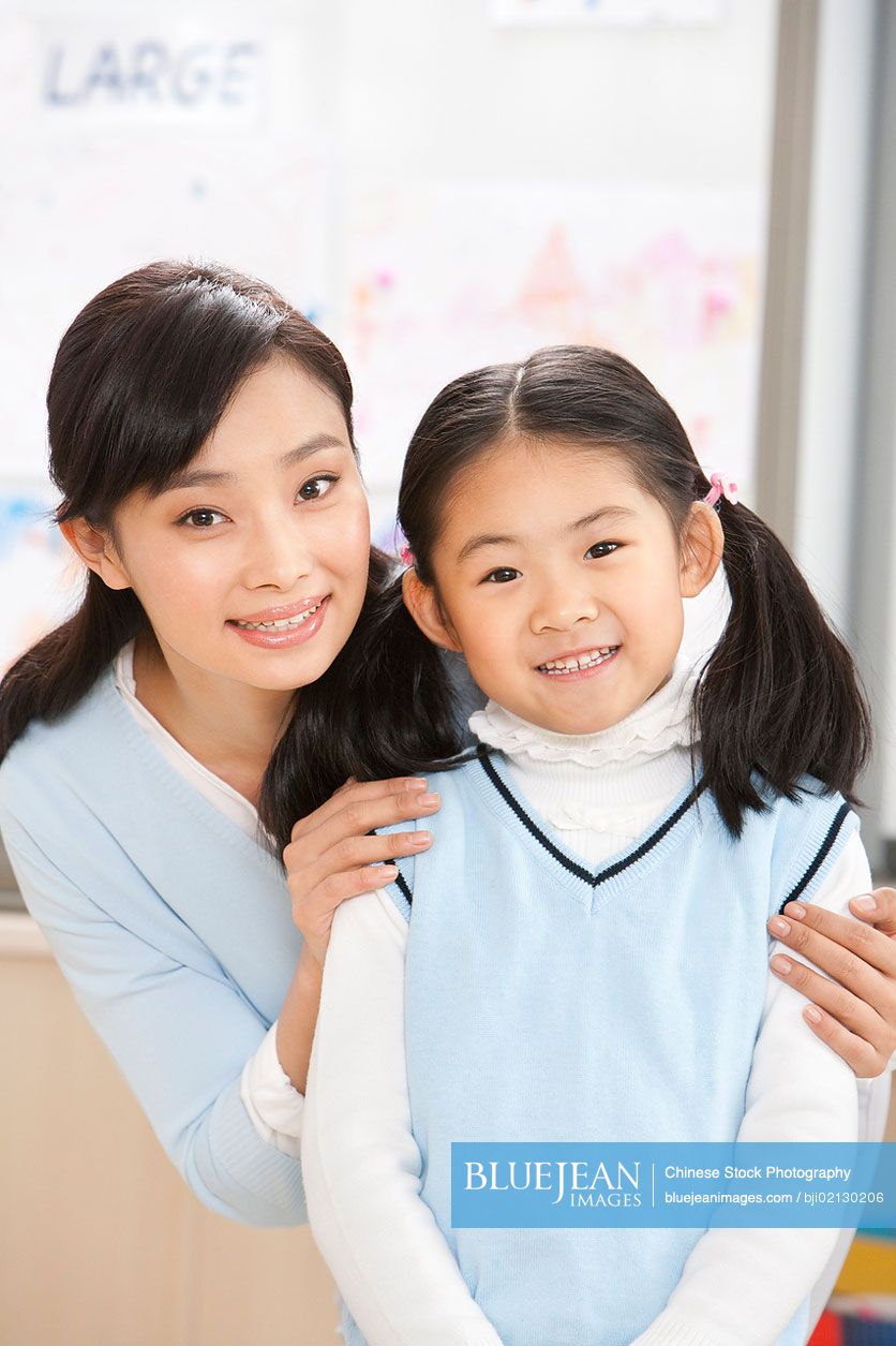 Chinese teacher bonding with her student-High-res stock photo for download