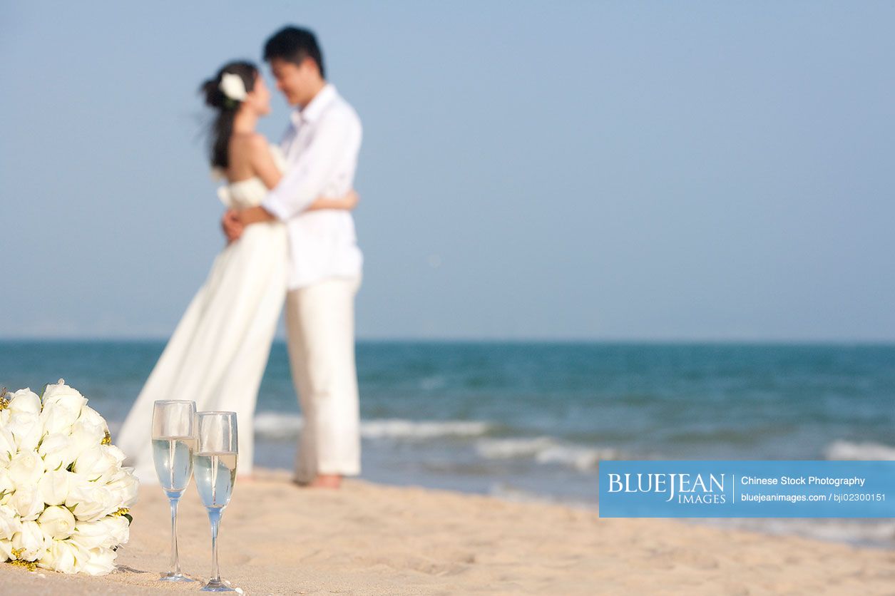 Chinese newlyweds celebrating on the beach-High-res stock photo for download