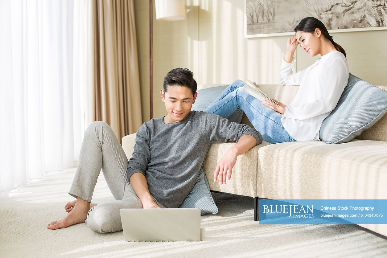 Young Chinese couple relaxing at home-High-res stock photo for download