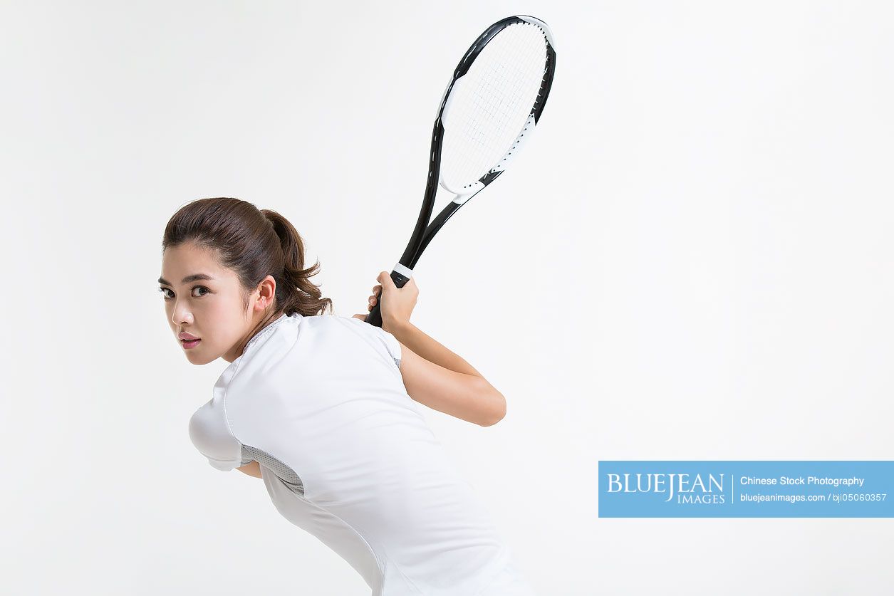Young Chinese woman playing tennis-High-res stock photo for download