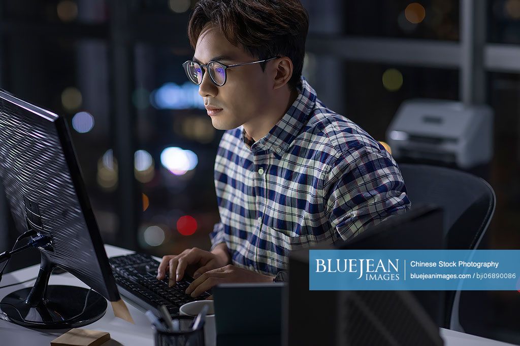Chinese IT worker working in office at night-High-res stock photo for ...