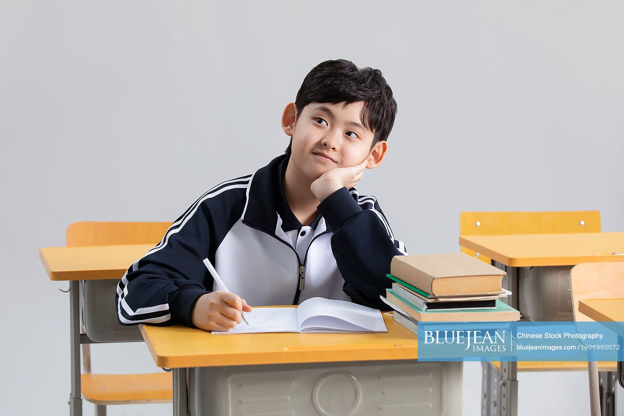 Chinese student thinking in classroom-High-res stock photo for download