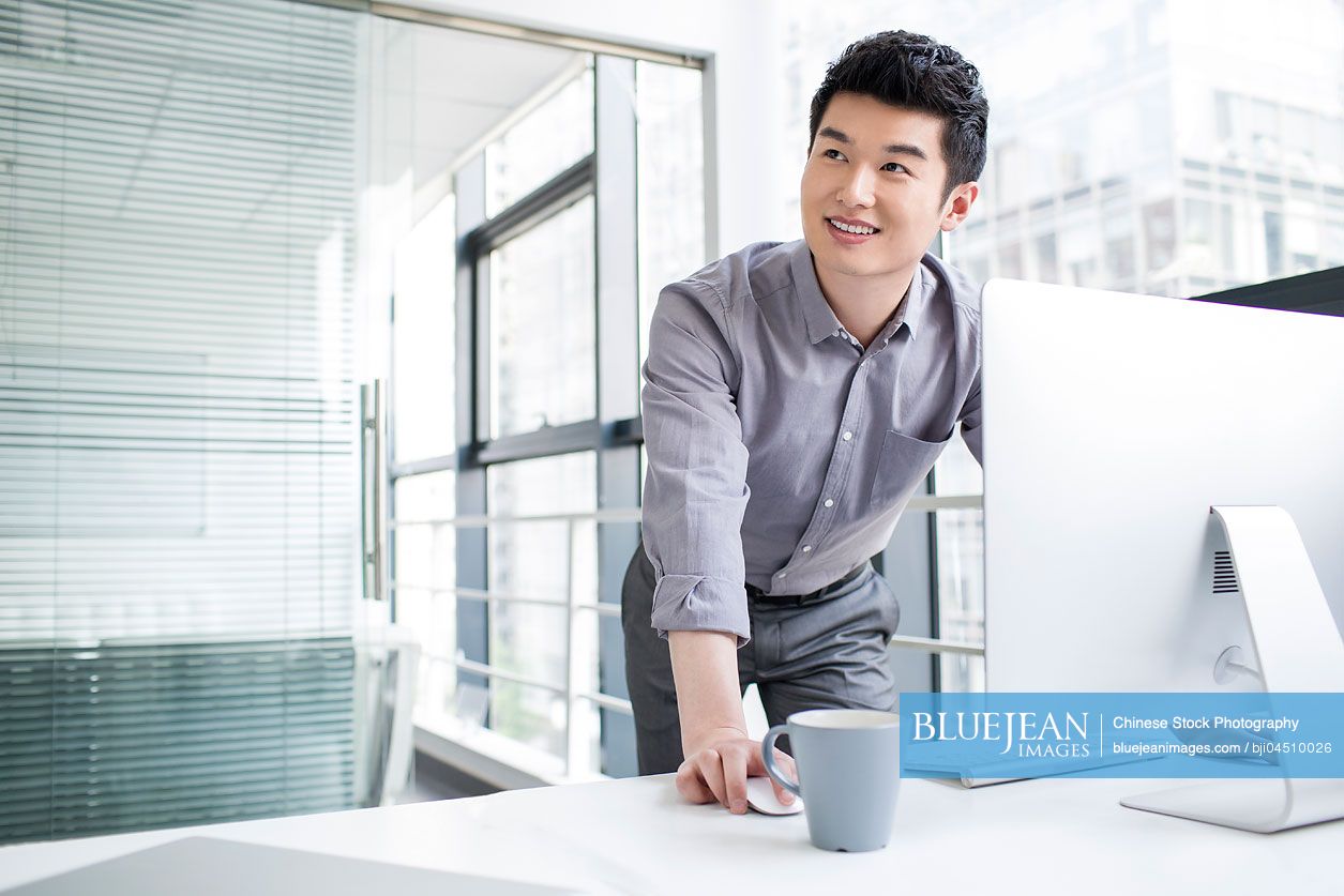Young Chinese businessman using computer in office-High-res stock photo ...
