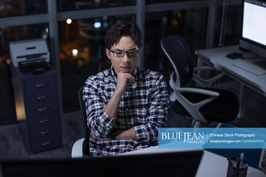 Chinese IT worker working in office at night-High-res stock photo for ...