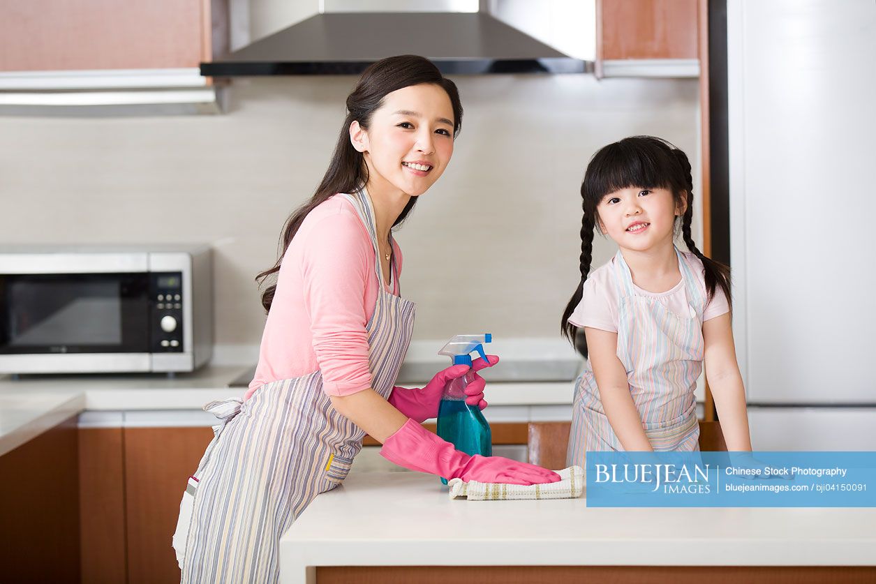 Chinese mother and daughter cleaning kitchen counter-High-res stock ...