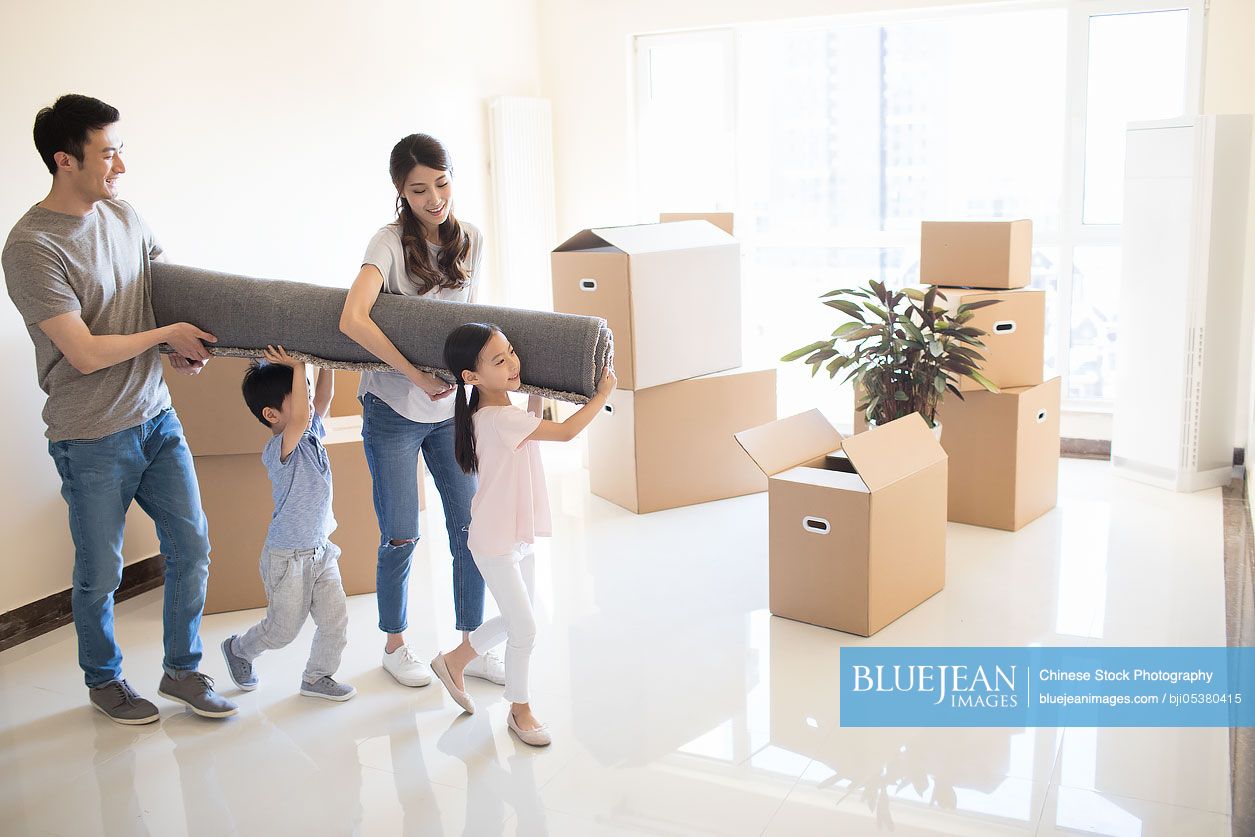 Happy young Chinese family moving to a new house-High-res stock photo ...