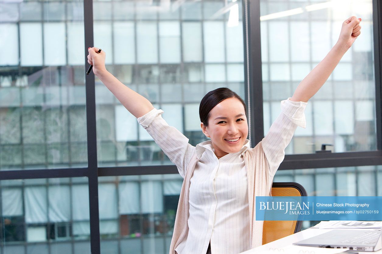 Chinese businesswoman with arms raised in celebration-High-res stock ...