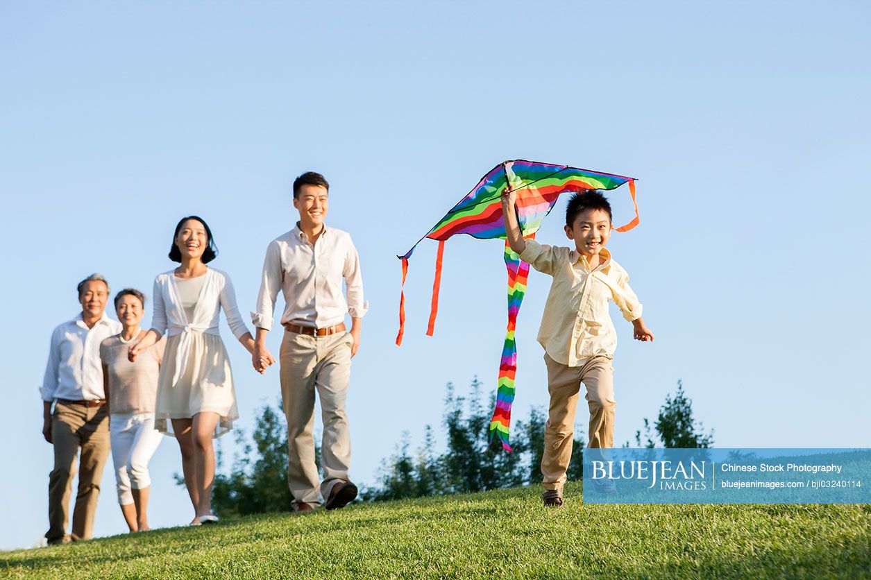 Chinese big family flying a kite in a park-High-res stock photo for download
