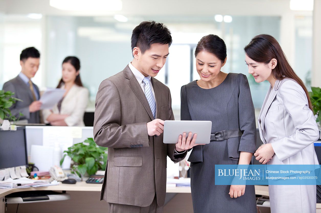 Happy Chinese business colleagues with digital tablet-High-res stock ...
