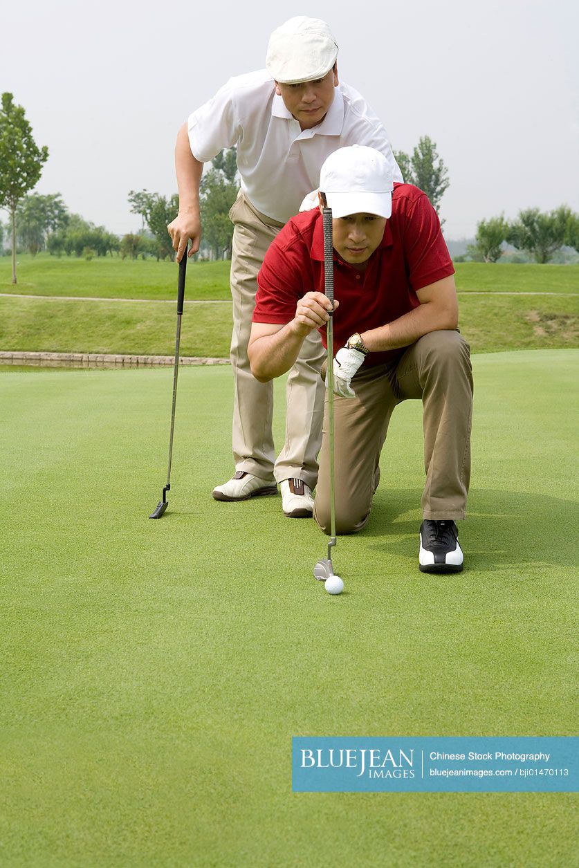Two male Chinese golfers on green-High-res stock photo for download