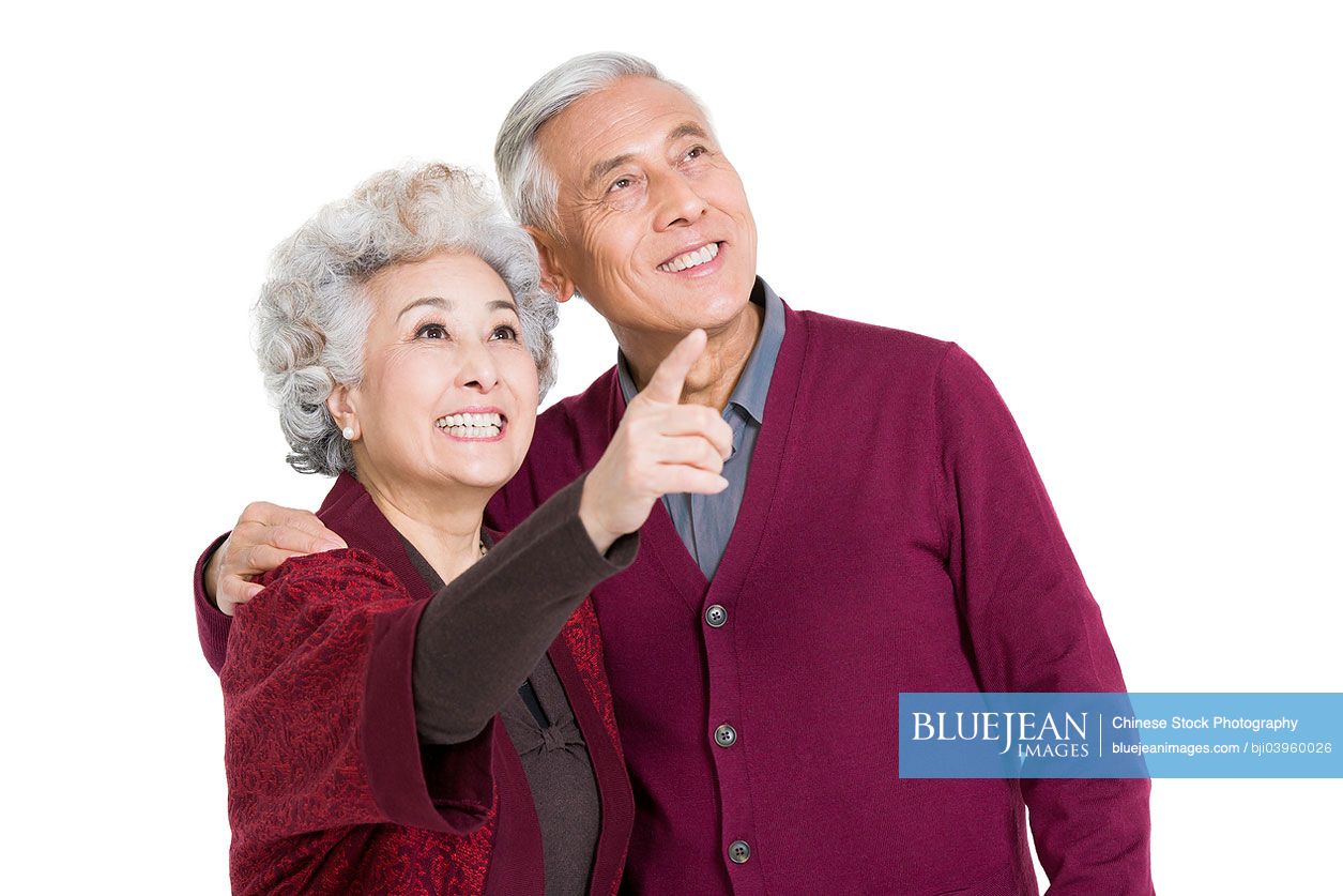 Cheerful Chinese senior couple pointing away-High-res stock photo for download