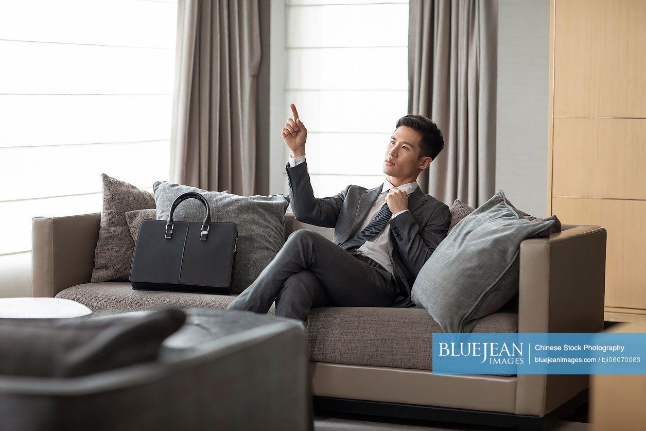 Young Chinese businessman and smart home-High-res stock photo for download