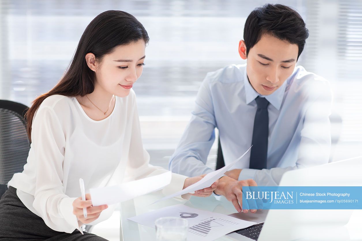 Young Chinese business people using laptop in office-High-res stock photo for download