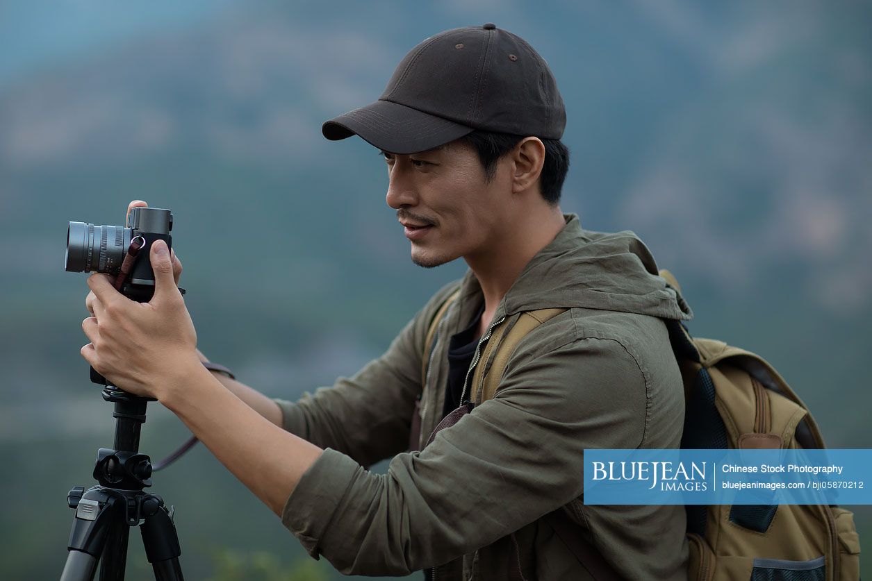 Chinese photographer taking photos outdoors-High-res stock photo for ...