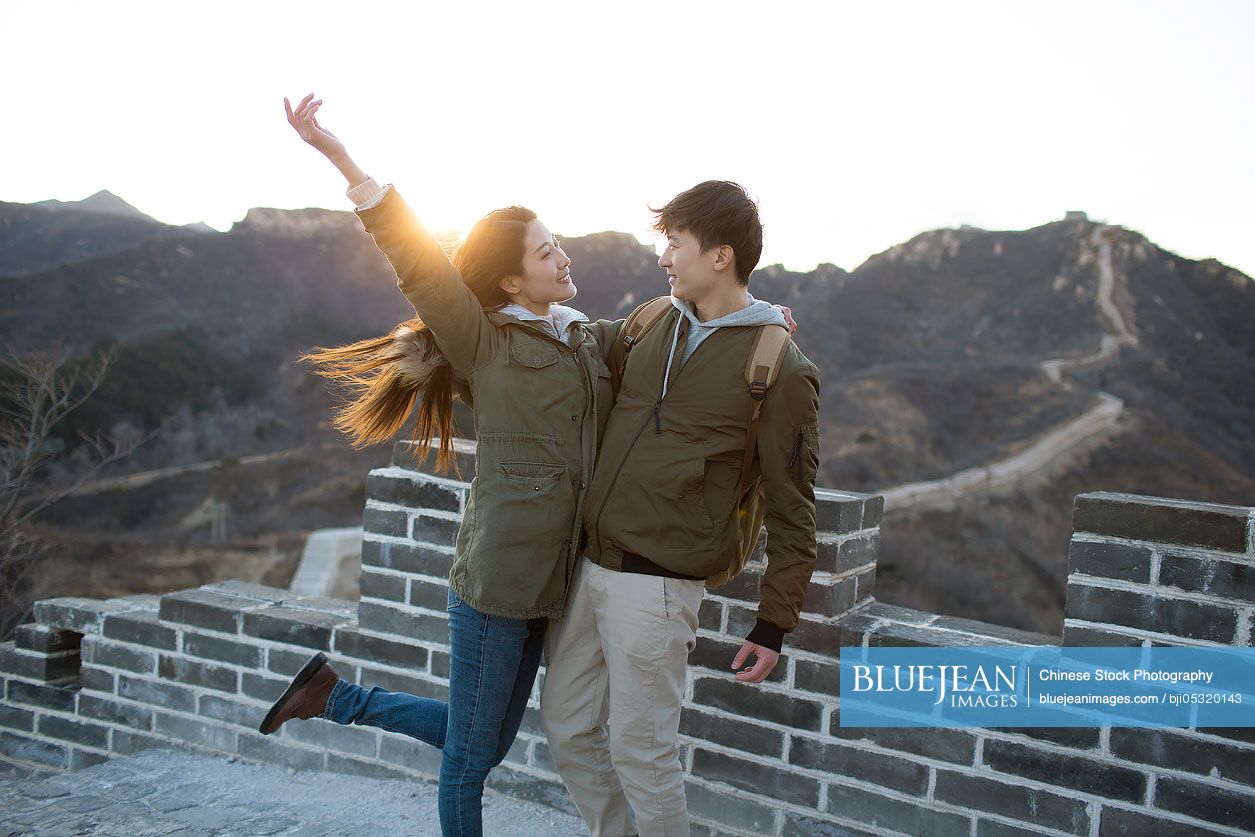 Happy young Chinese couple enjoying winter outing on the Great Wall-High-res stock photo for ...