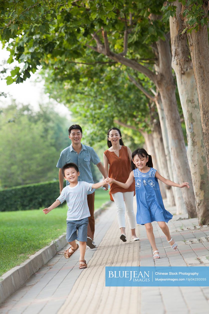 Happy Chinese brother and sister holding hands jumping-High-res stock ...