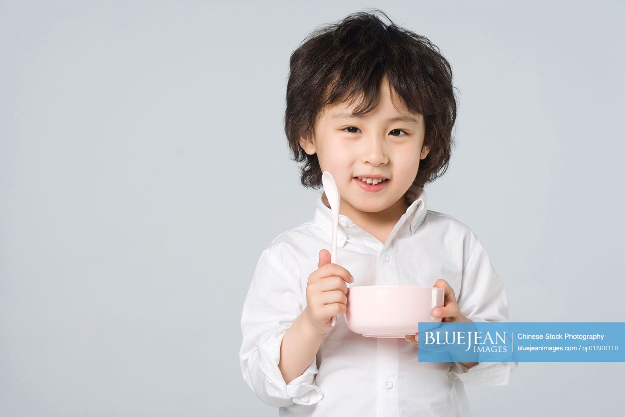 Little Chinese boy holding a bowl and spoon-High-res stock photo for ...
