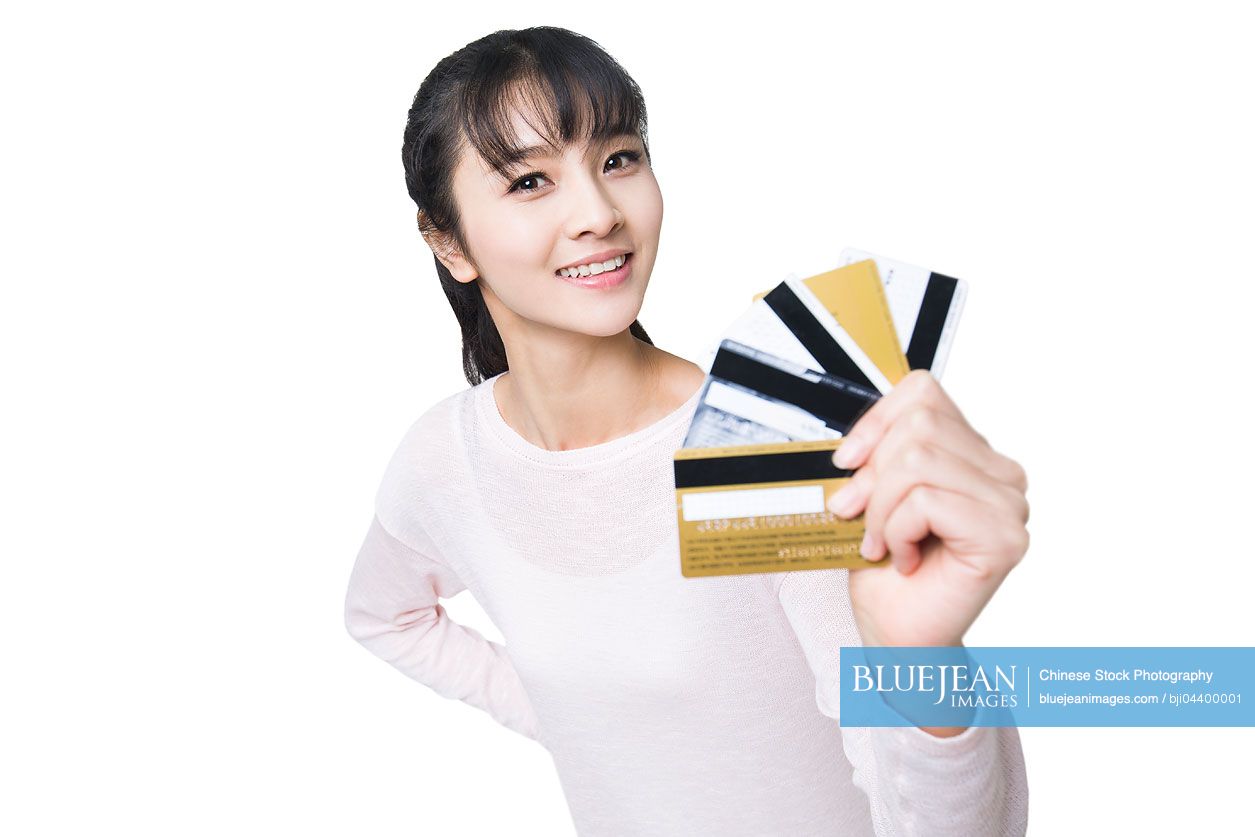 Young Chinese woman holding credit cards-High-res stock photo for download