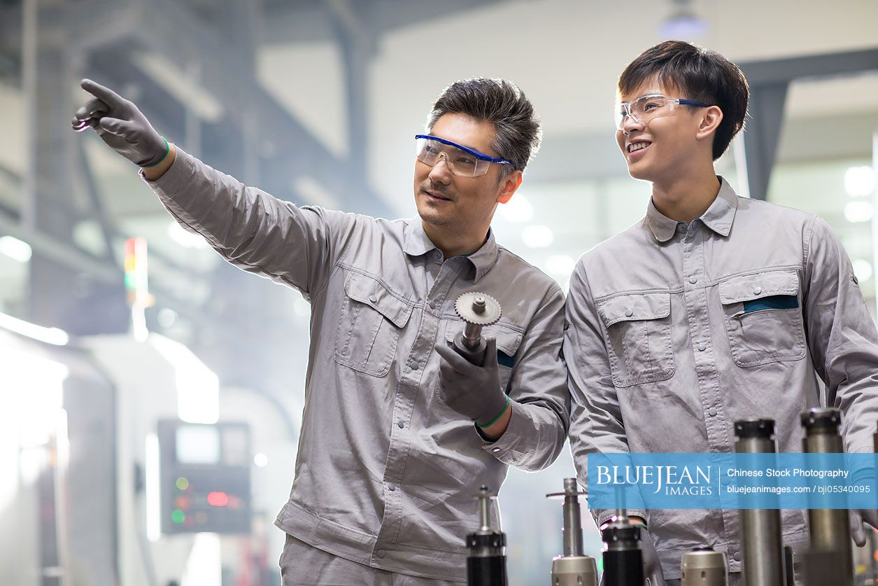 Confident Chinese engineers working in the factory-High-res stock photo ...