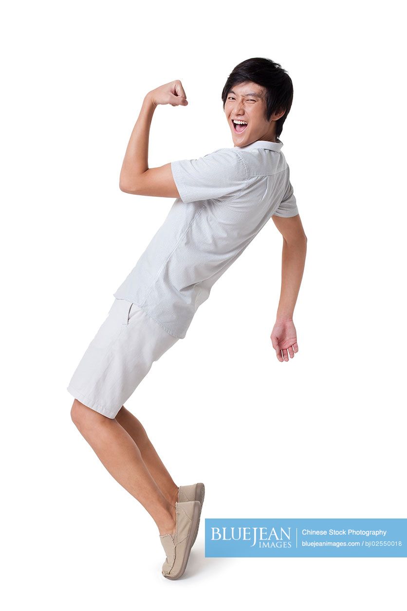 Young Chinese man standing on tiptoes-High-res stock photo for download