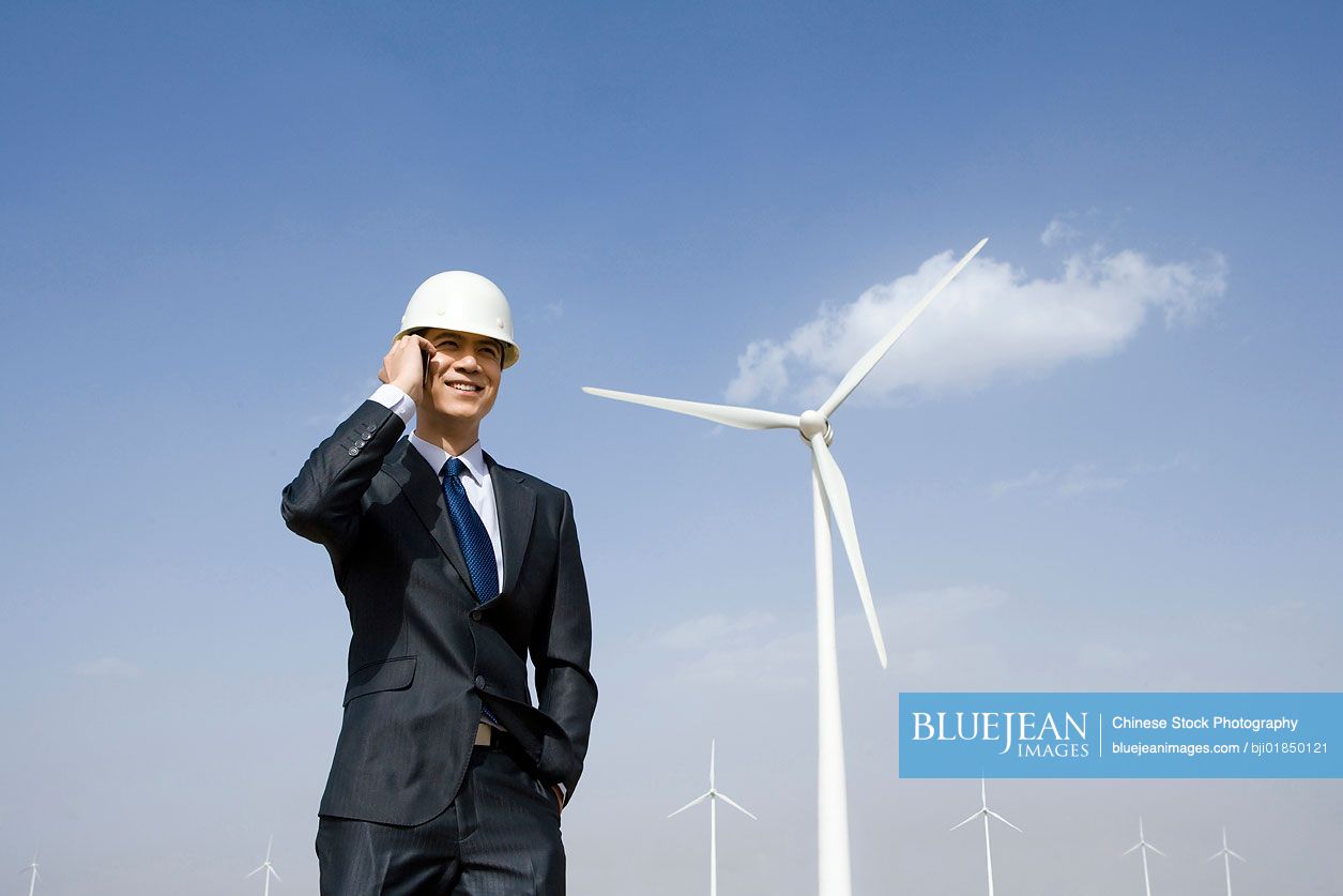 Chinese engineer in front of wind turbines-High-res stock photo for ...