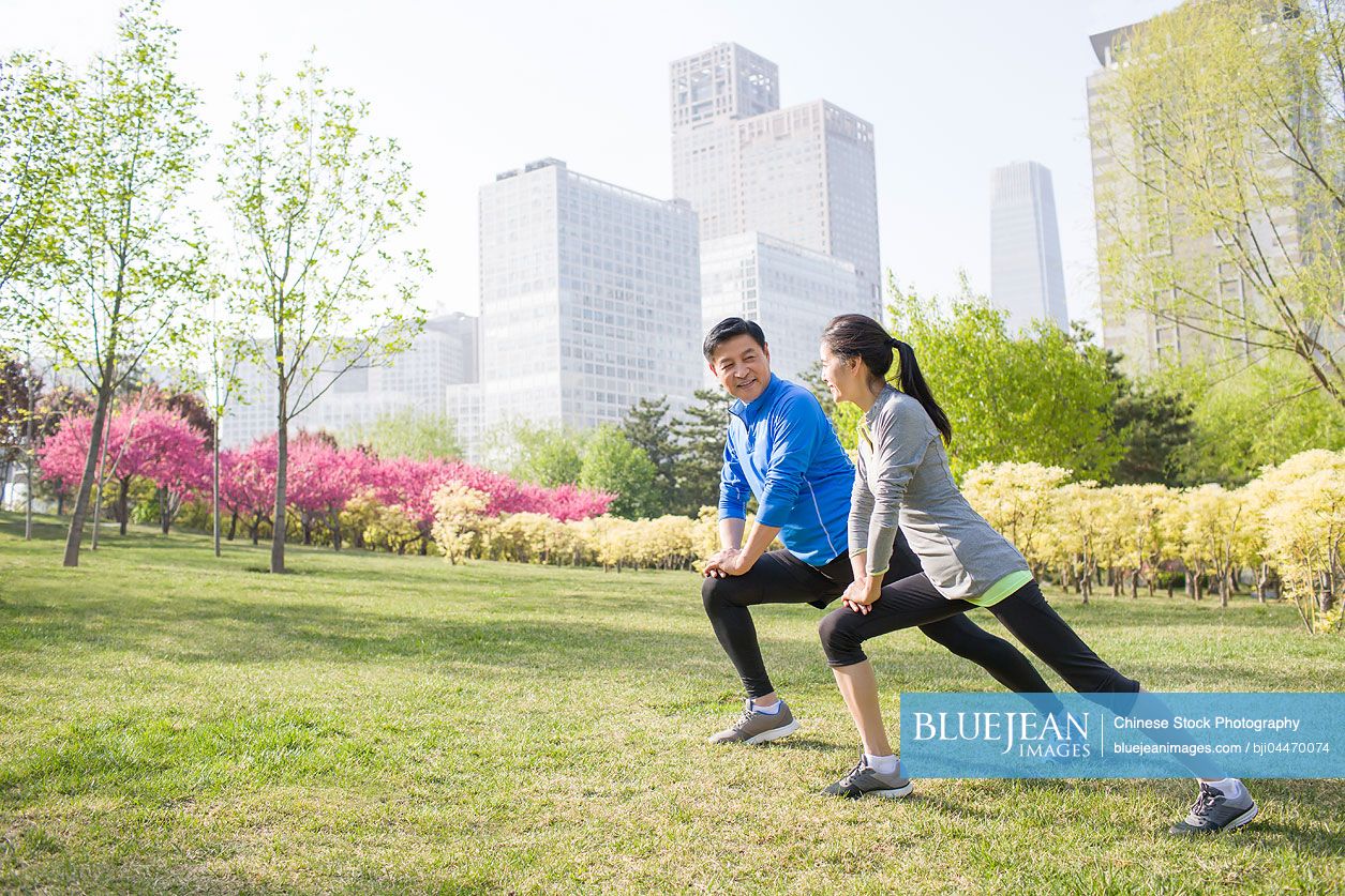 Happy mature Chinese couple exercising in park-High-res stock photo for download