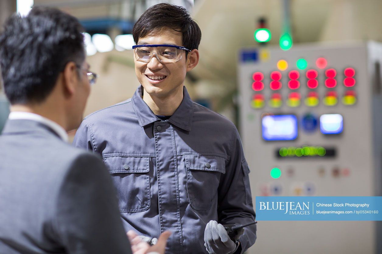 Chinese businessman and engineer talking in the factory-High-res stock ...