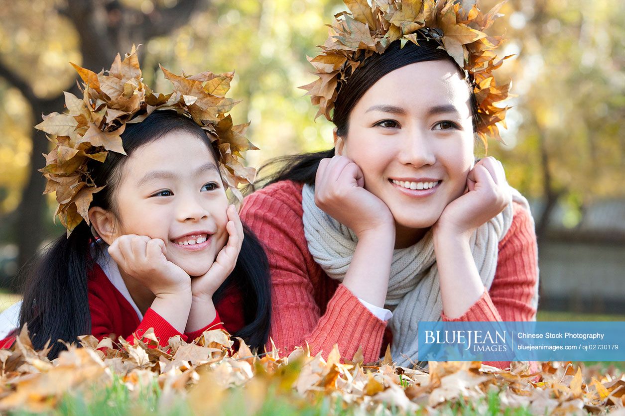 Chinese mother and daughter with a crown of autumn leaves-High-res stock photo for download
