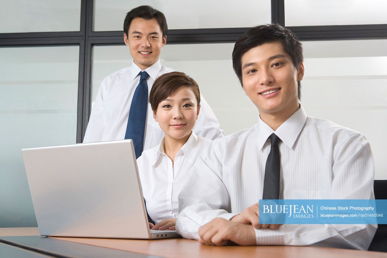 Young Chinese businessmen and businesswoman in office-High-res stock ...