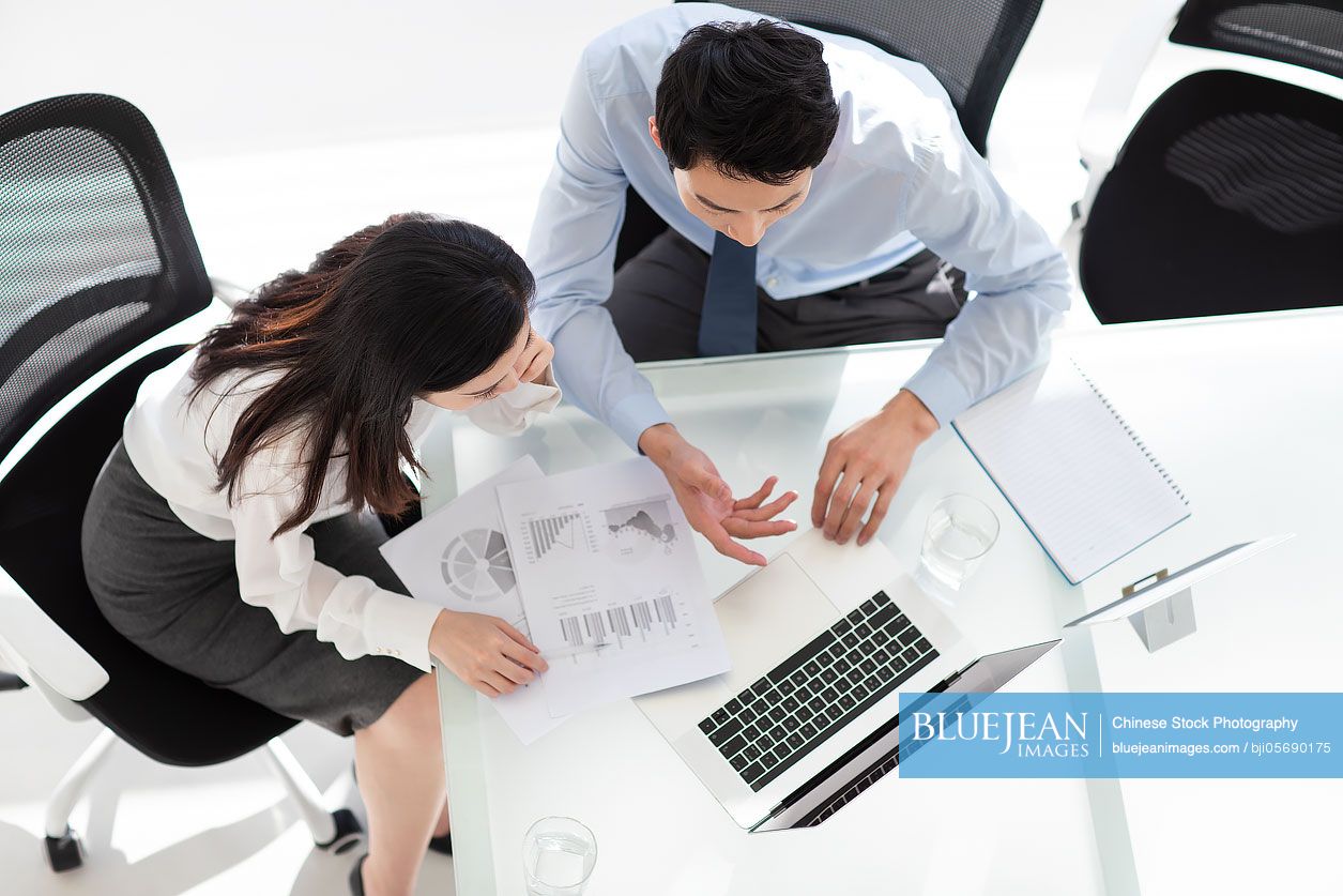 Young Chinese business people using laptop in office-High-res stock photo for download