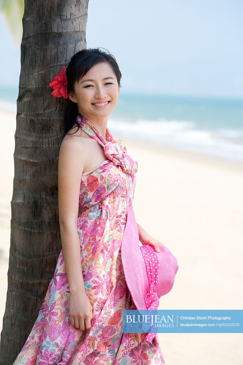 Happy young Chinese woman on vacation-High-res stock photo for download