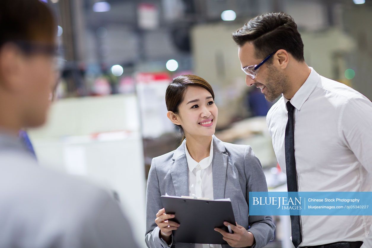 Businessman and businesswoman talking in the factory-High-res stock ...
