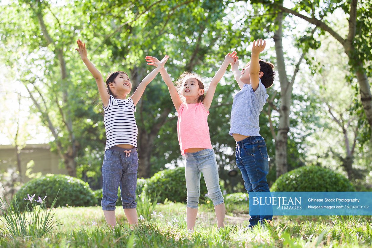 Happy Chinese children playing in woods-High-res stock photo for download