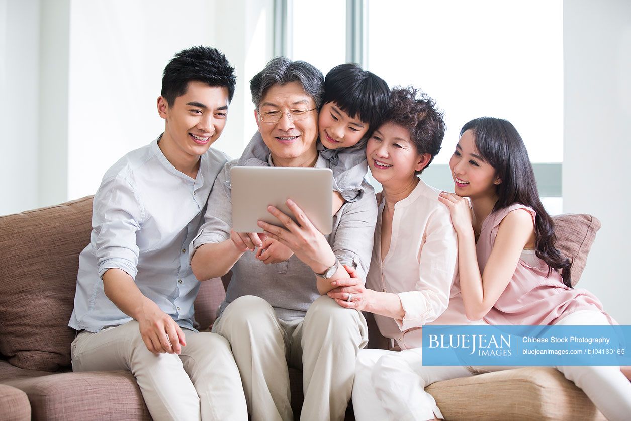 Happy Chinese family with digital tablet-High-res stock photo for download
