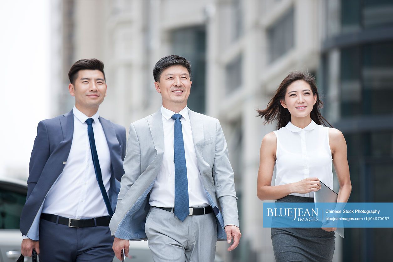 Confident Chinese business team on the move-High-res stock photo for ...