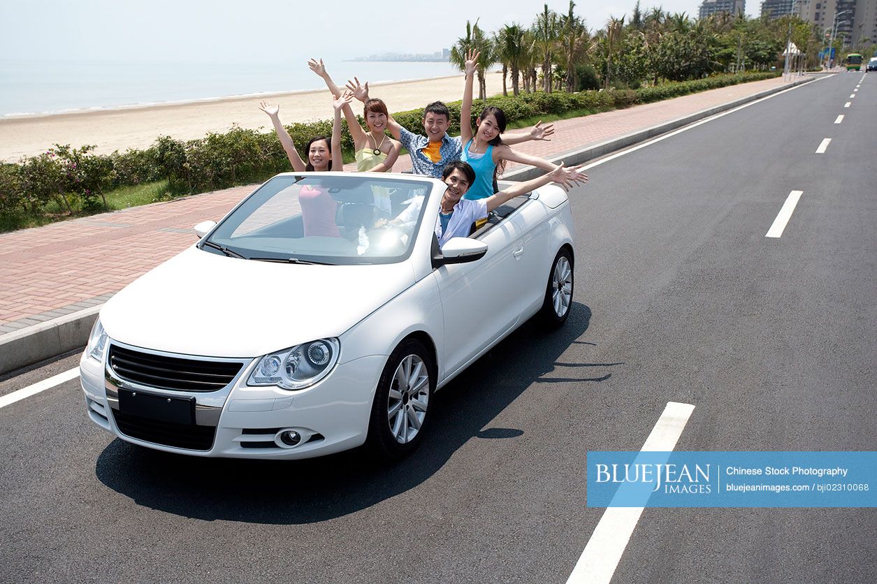 Chinese friends having fun in a convertible-High-res stock photo for ...