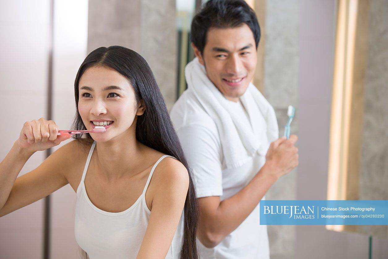 Young Chinese couple brushing teeth together-High-res stock photo for ...