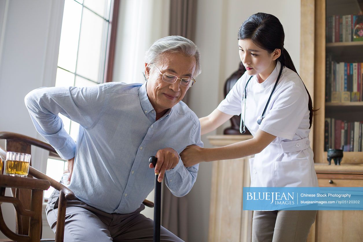 Chinese nursing assistant taking care of senior man-High-res stock ...