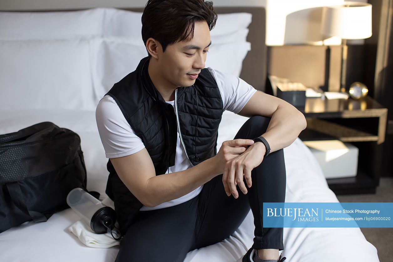 Chinese mid adult man getting ready to go out and workout-High-res ...