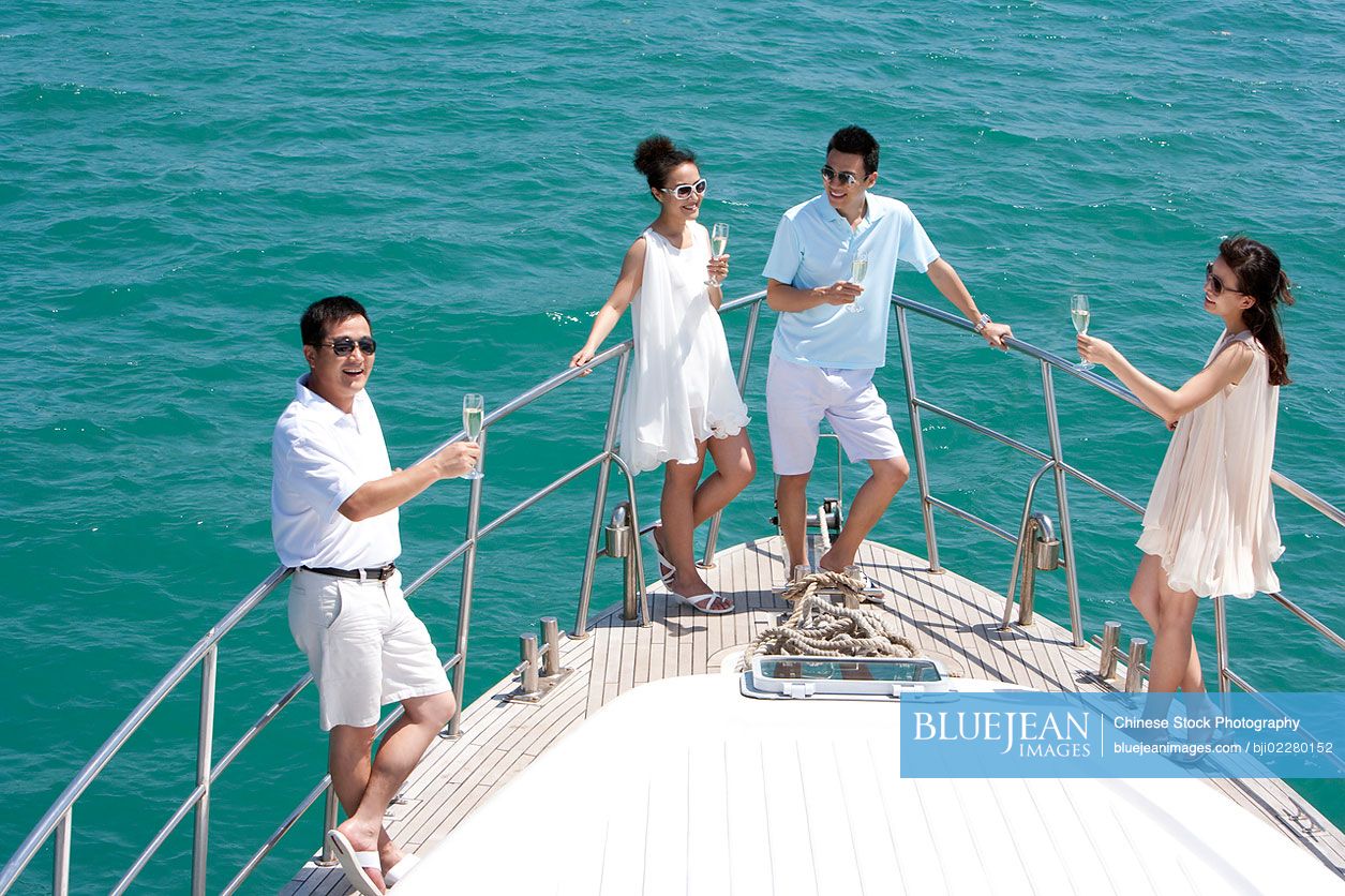 Chinese friends relaxing on a yacht-High-res stock photo for download