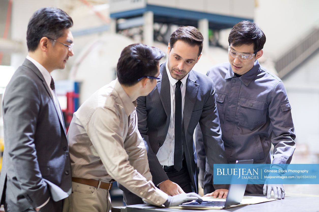 Businessmen and engineers talking in the factory-High-res stock photo ...