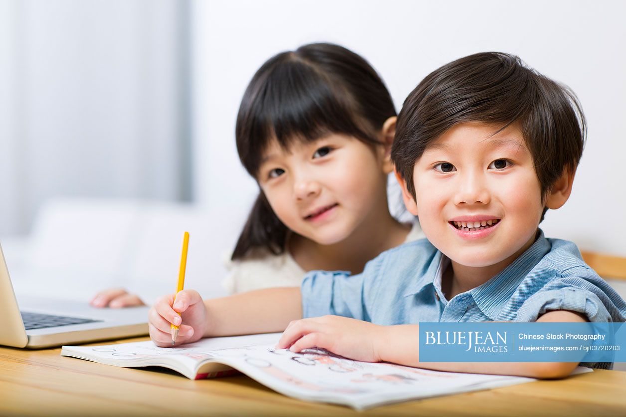 Little Chinese boy and girl doing homework-High-res stock photo for ...