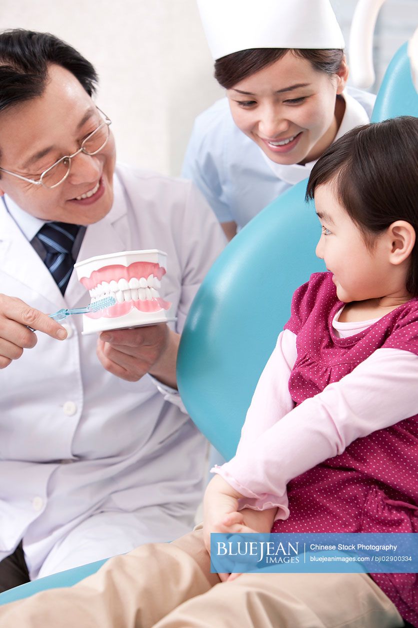 Chinese dentist teaching the right way of brushing teeth-High-res stock ...
