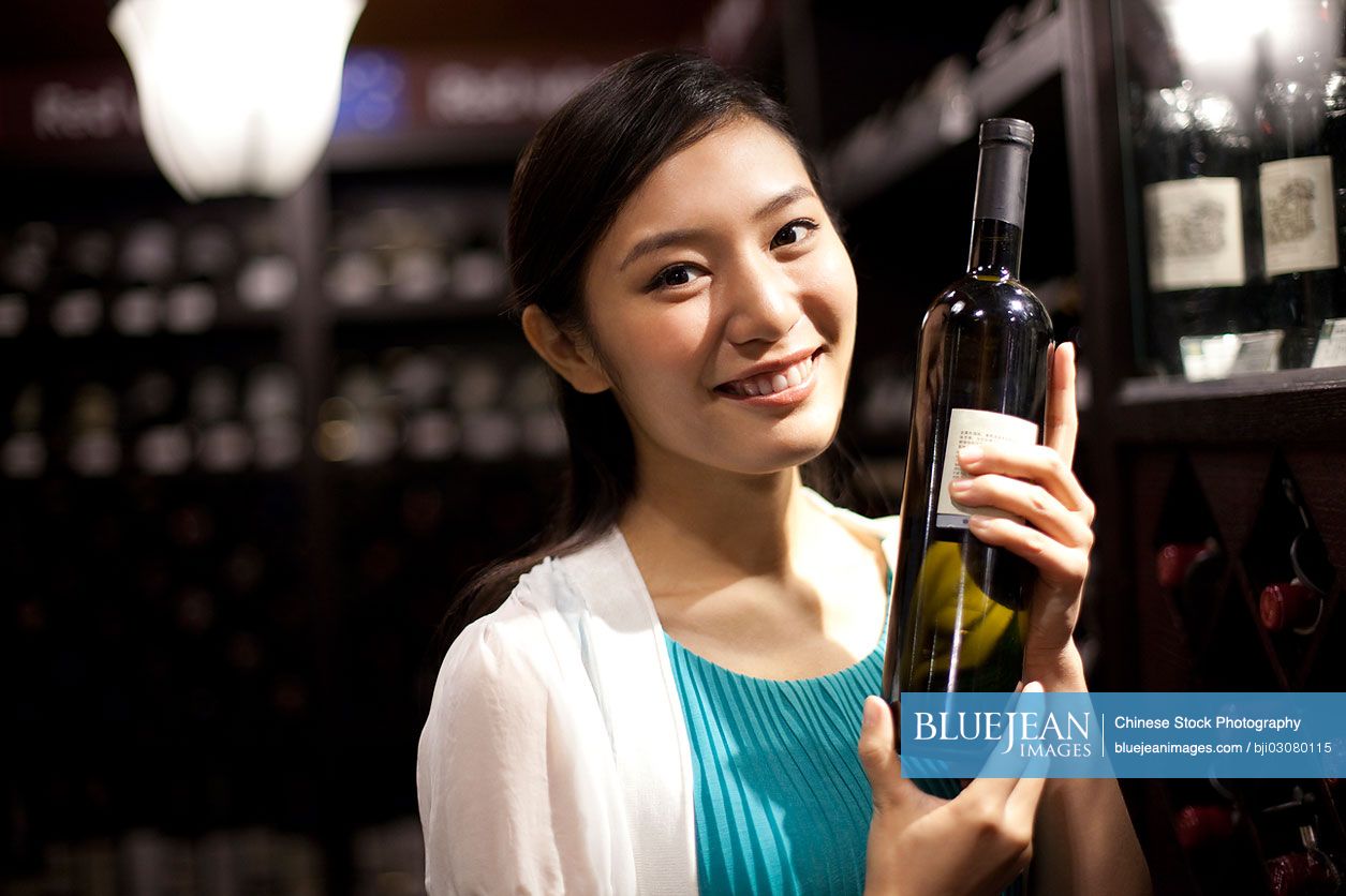 Young Chinese Woman Shopping In Cellar High res Stock Photo For Download