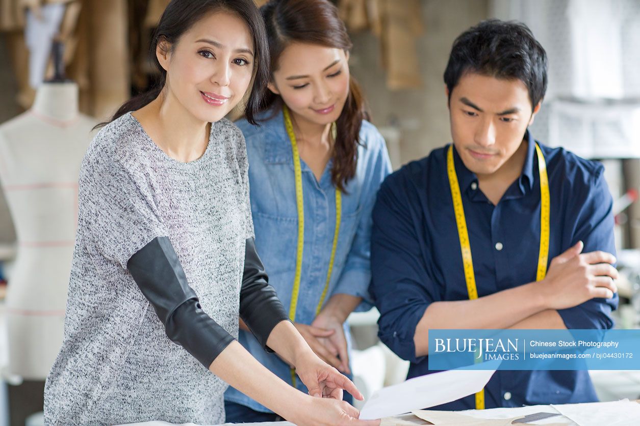Chinese fashion designers talking in studio-High-res stock photo for ...