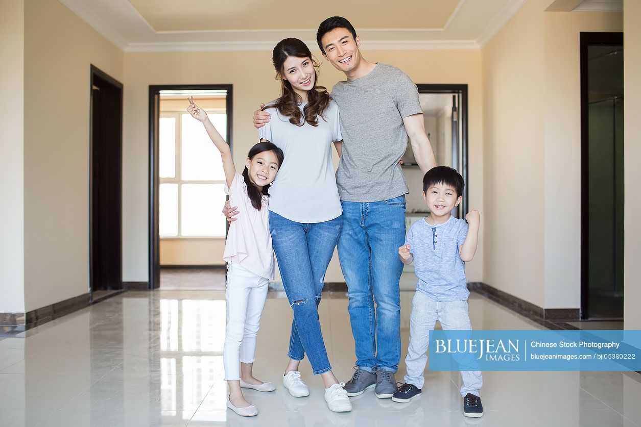 Happy young Chinese family holding keys in their new house-High-res ...