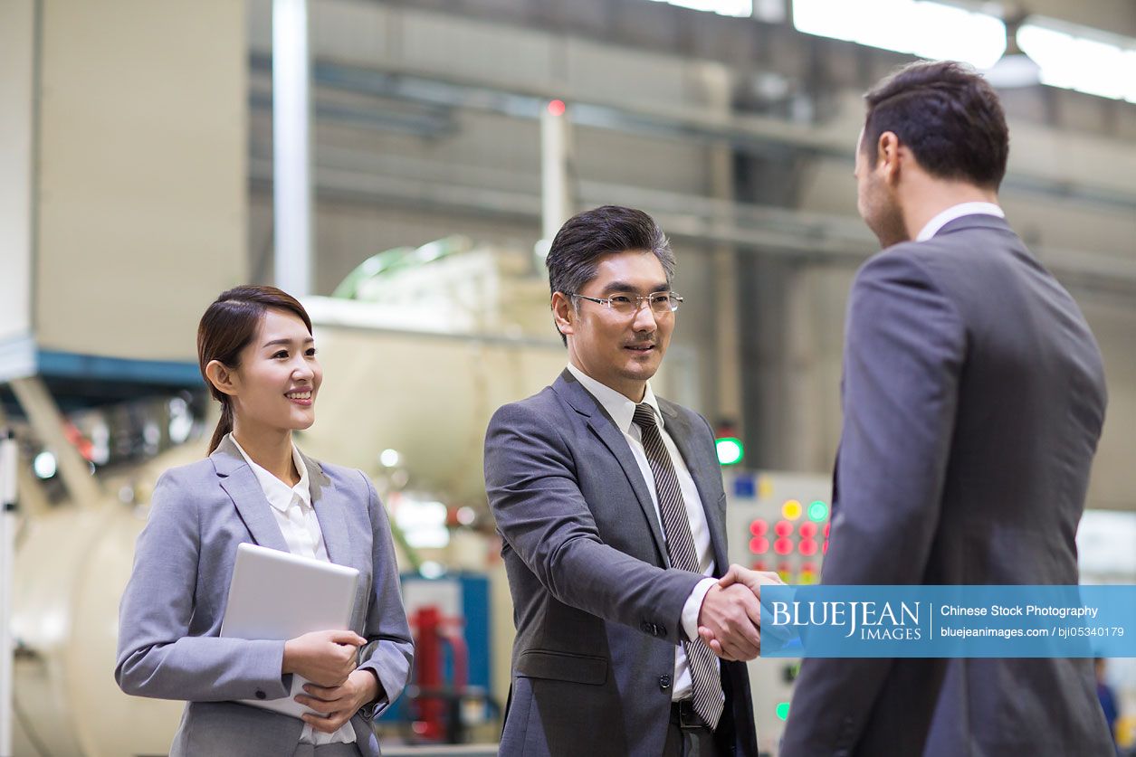 Business people shaking hands in the factory-High-res stock photo for ...