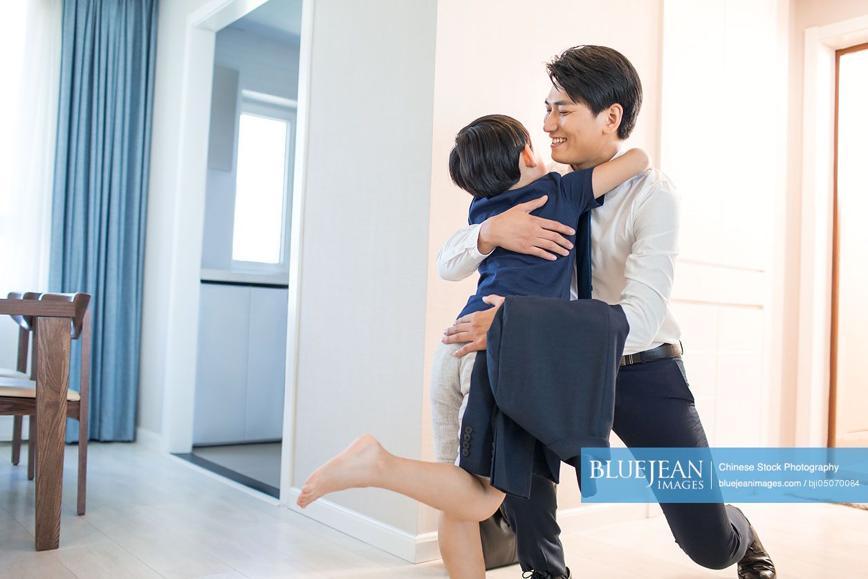 Young Chinese father come back home from work-High-res stock photo for ...