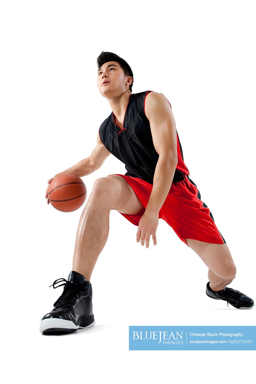 Chinese man dribbling basketball-High-res stock photo for download